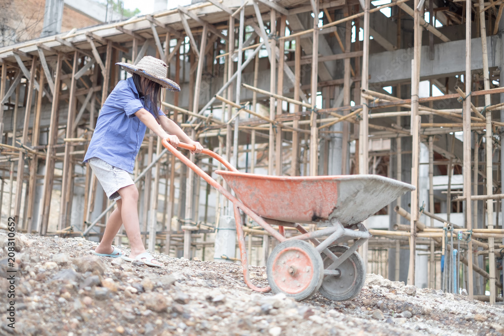 Little girl labor working in commercial building structure, World Day ...