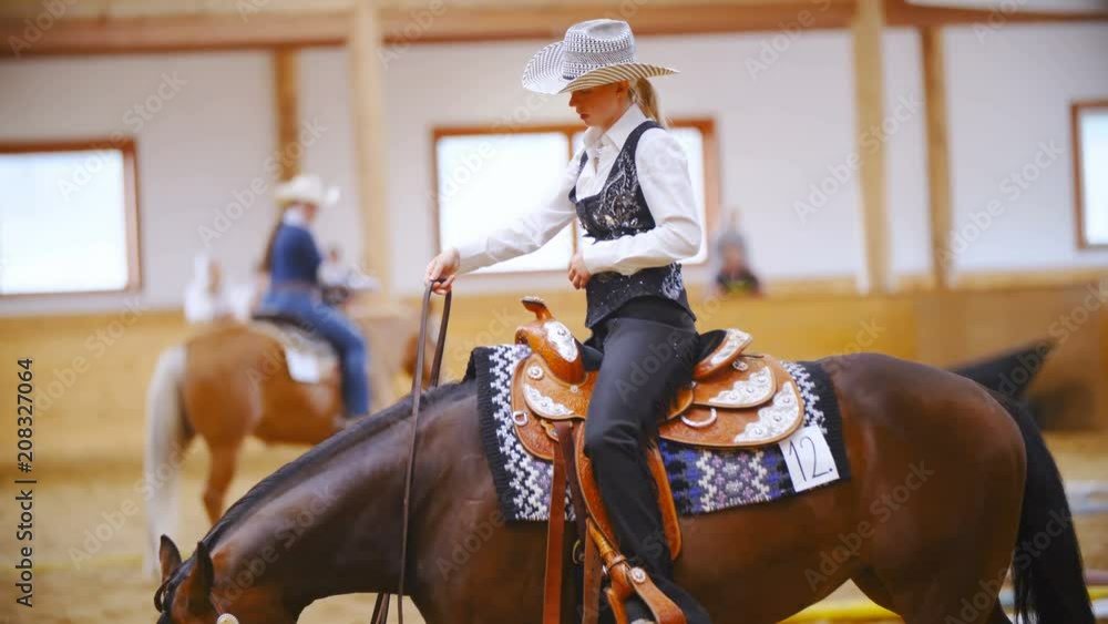 Attractive female western rider at a horsemanship competition 4K. Long ...