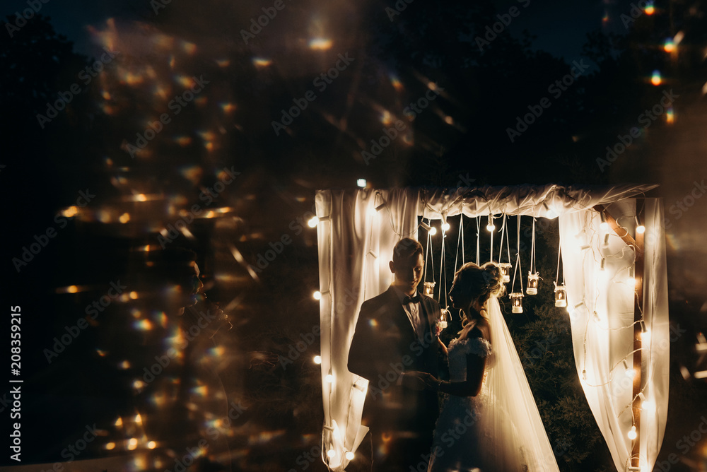 Stylish couple in romantic loft decorations at night. Romantic ...
