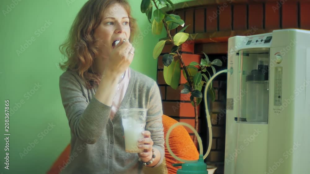 A woman drinks an oxygen cocktail with a device for oxygen scum. Oxygen ...