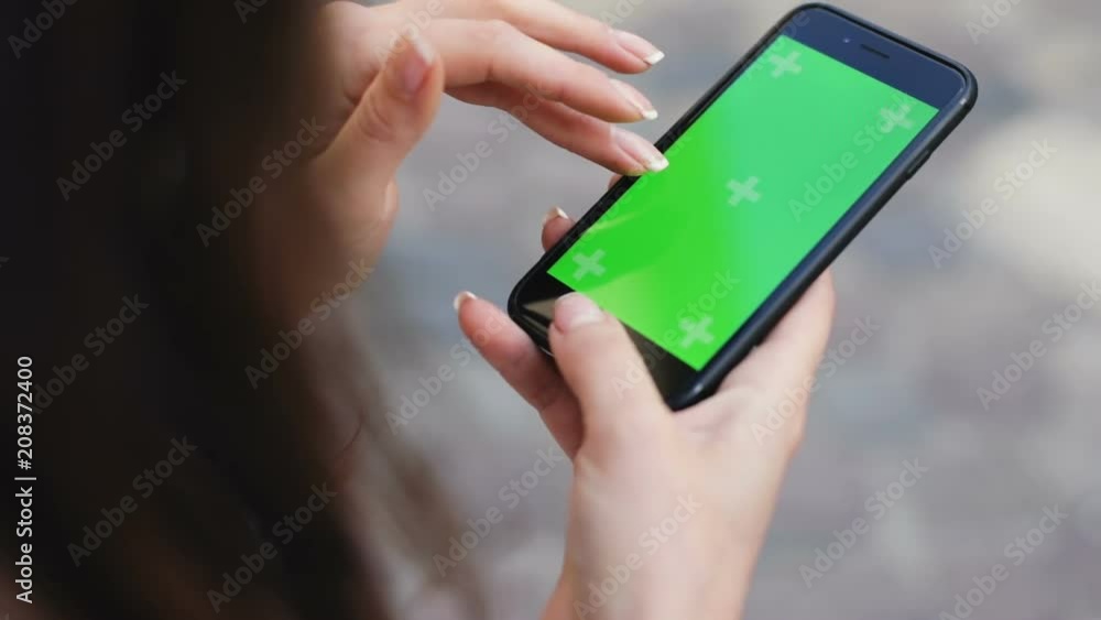 woman hands using cellular telephone smartphone with touch green screen ...