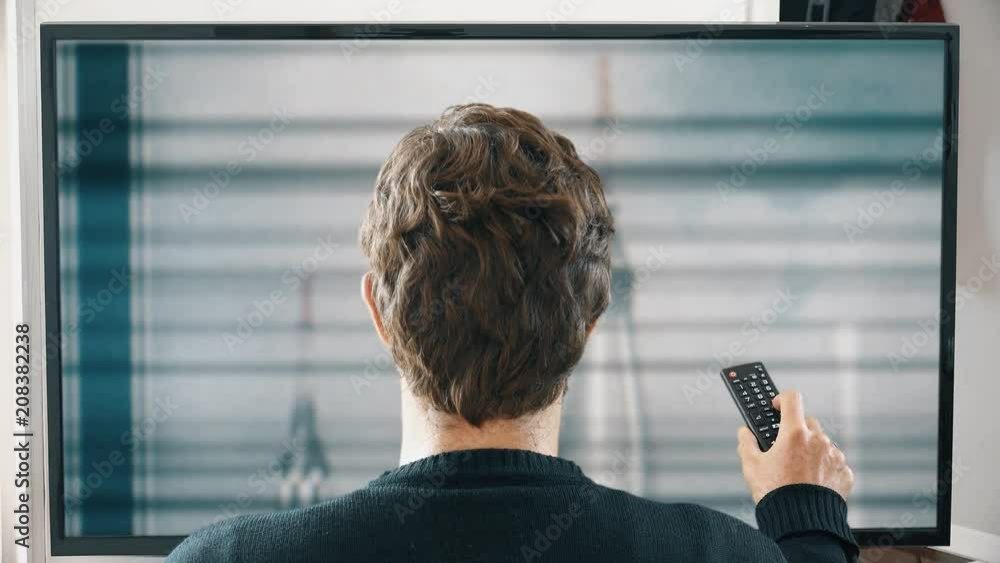 Channel Surfing TV Television Interference Signal. Man using a remote ...