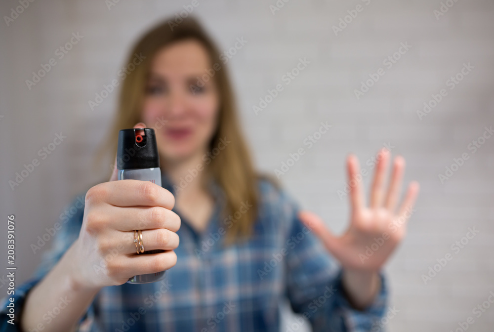 Married woman is holding pepper spray canister for personal protection ...