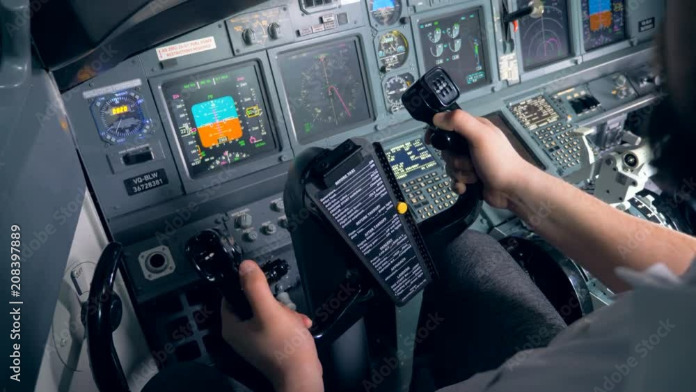 An airman is managing a control wheel in a plane's cockpit vídeo de ...