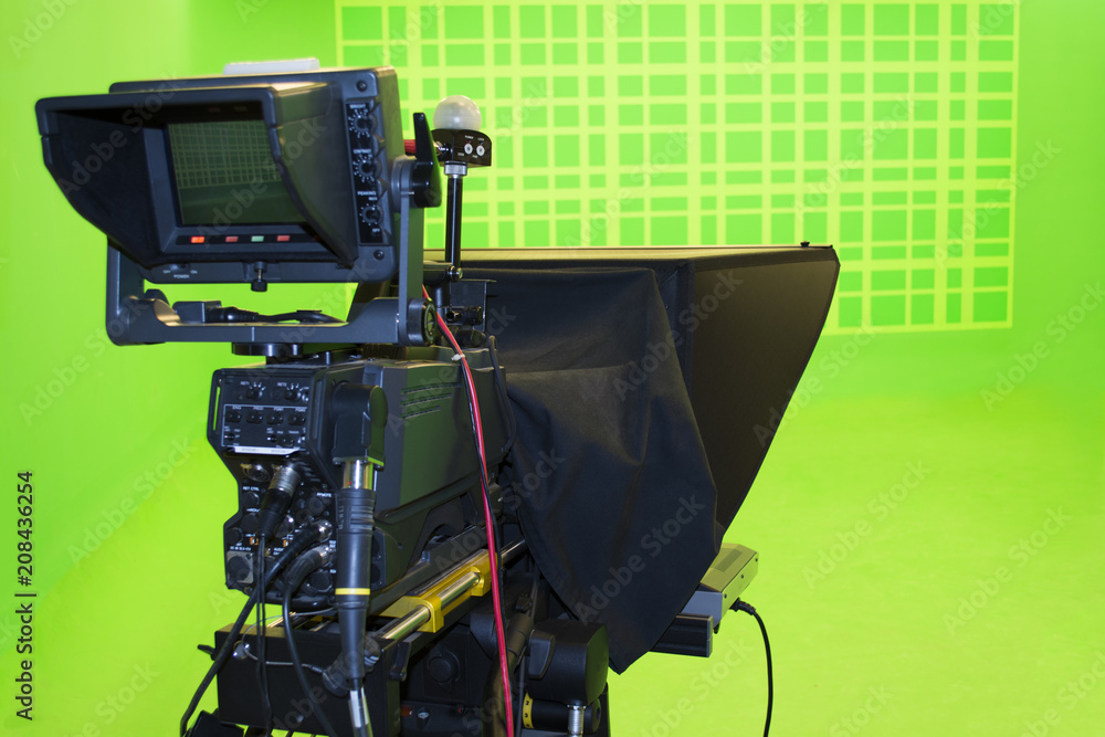 Broadcast television studio camera in green screen studio room with LED ...