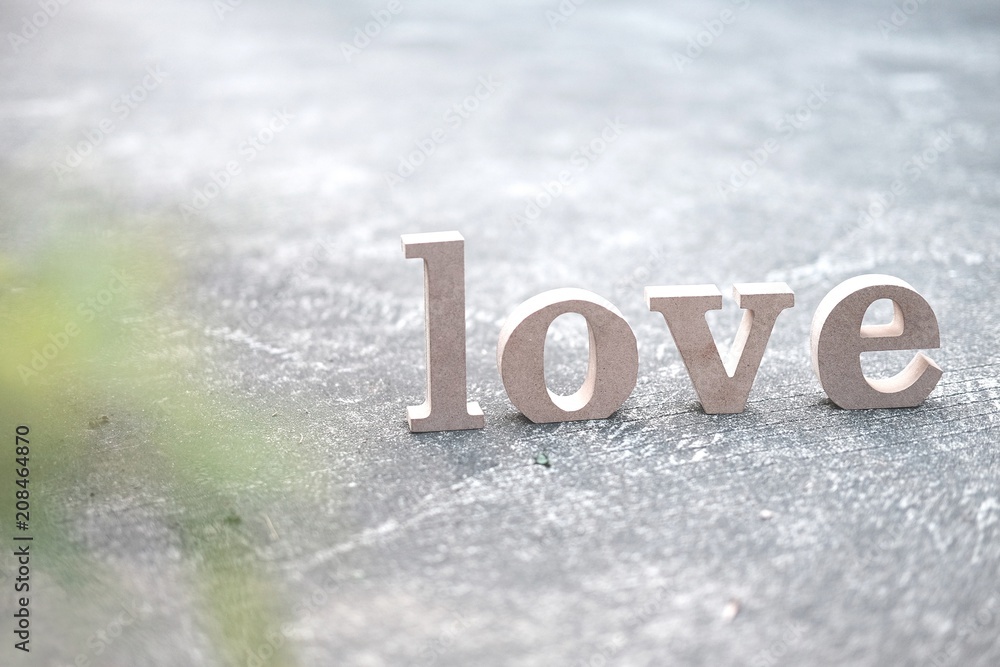Wooden letters word "LOVE" on concrete floor.Love text in nature garden ...