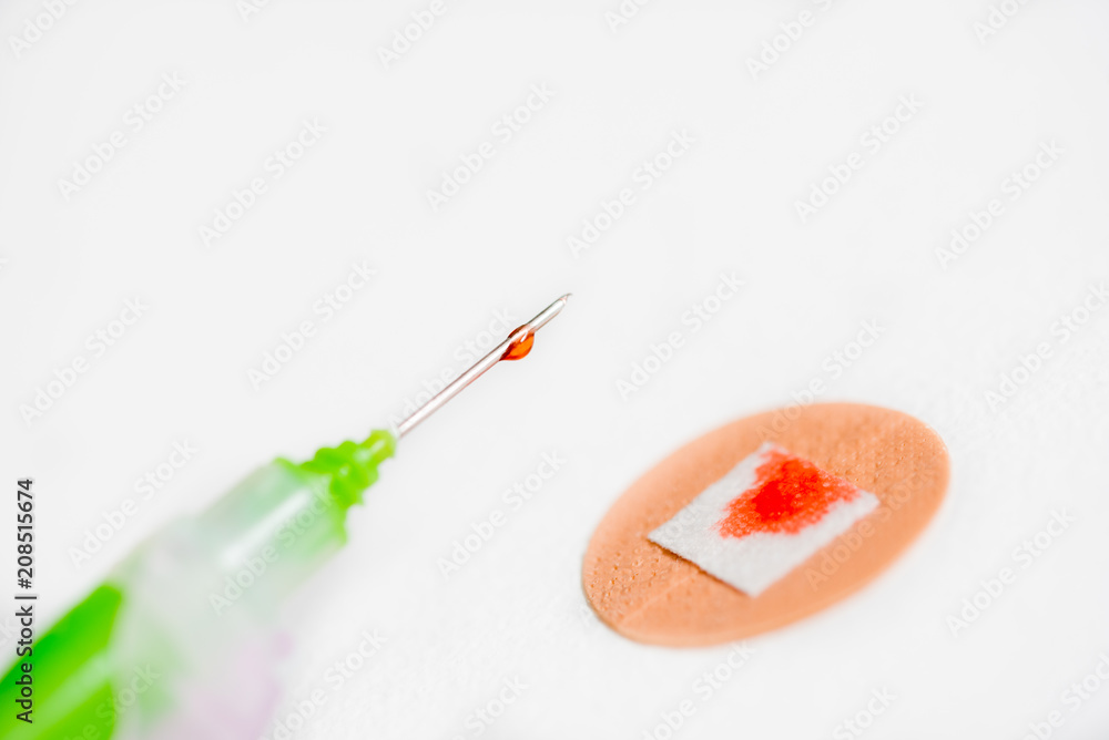 Drop of red liquid on an injection needle Stock Photo | Adobe Stock