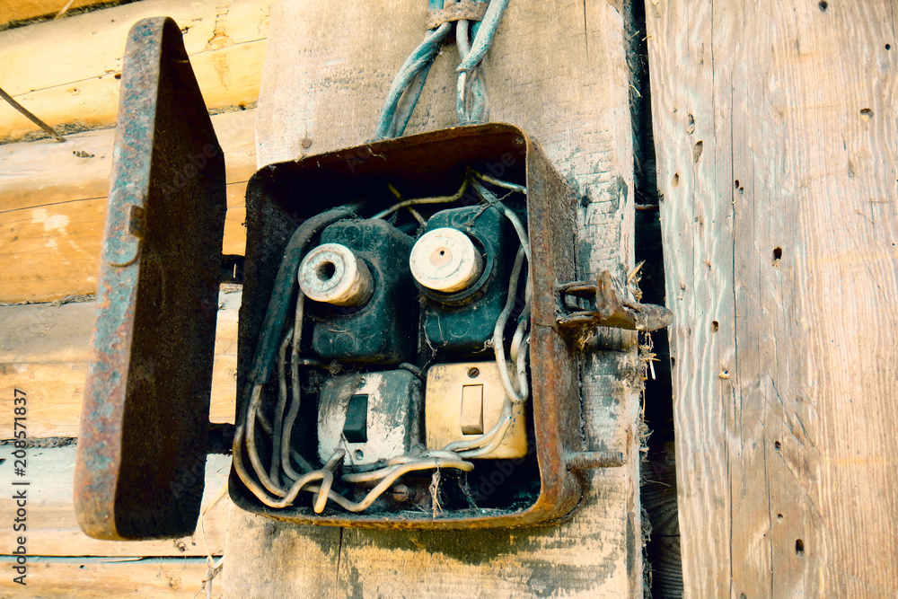 Old electric power supply boxes. Industrial background. Overloaded ...