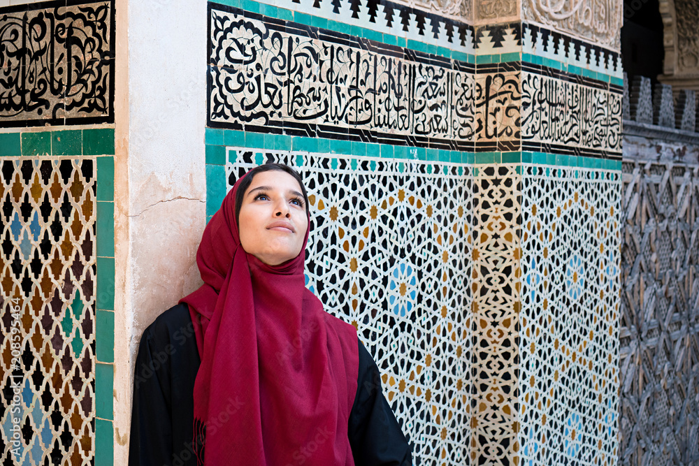 Muslim woman in traditional clothing with red hijab and black dress in ...