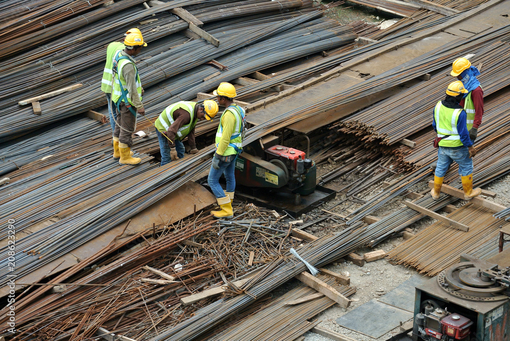 Construction workers working at the steel reinforcement bar bending ...