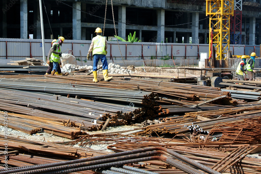 Construction workers working at the steel reinforcement bar bending ...