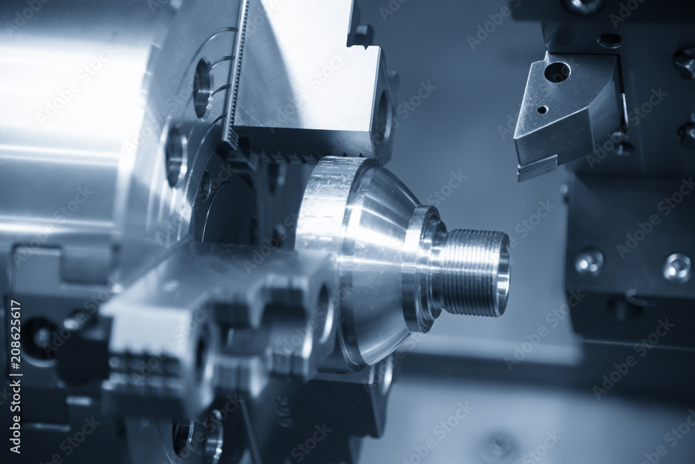 The CNC lathe or turning machine cutting the thread at cone shape part ...