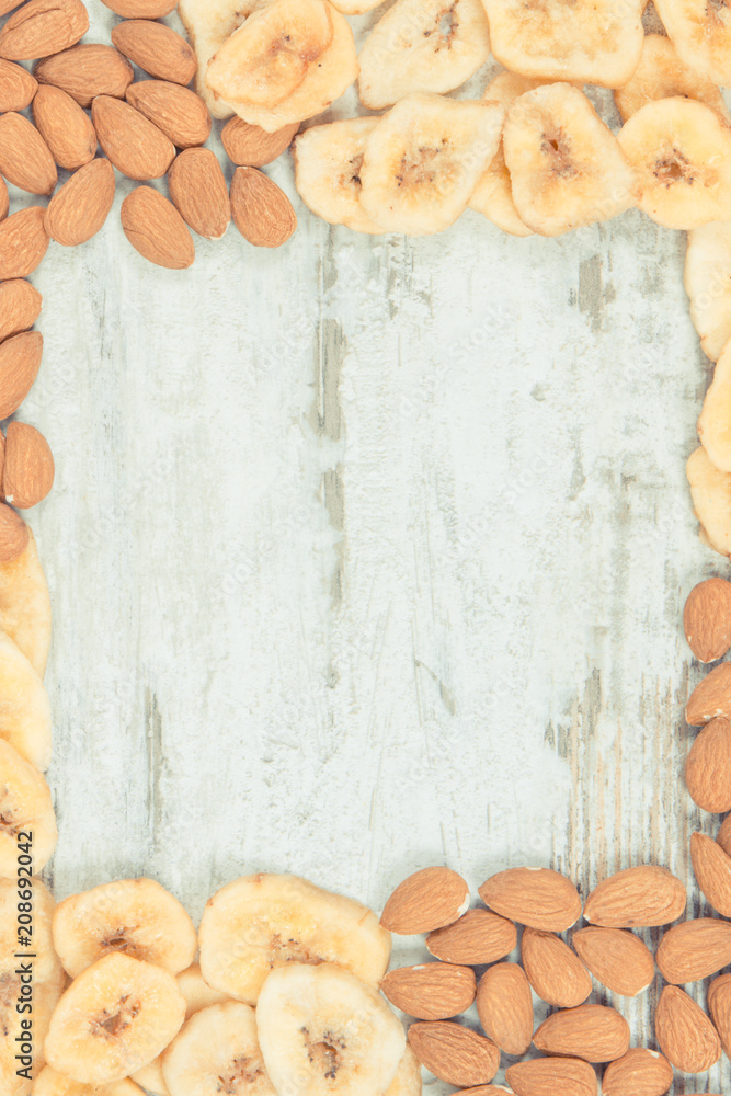 Frame of almonds and banana chips as source carbohydrates, vitamins and ...