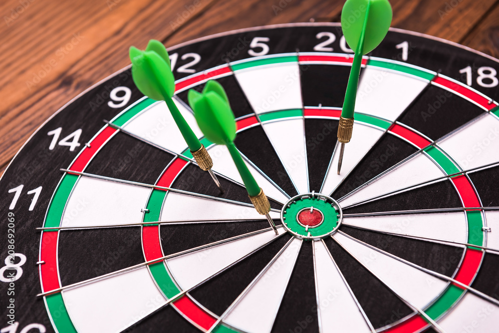 Darts missing the bullseye Stock Photo | Adobe Stock