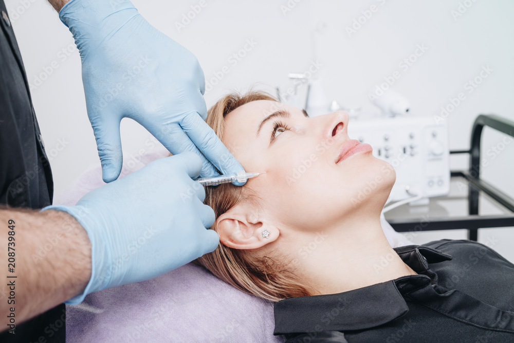 Syringe with an injection in the hands of a doctor. Syringe for beauty ...