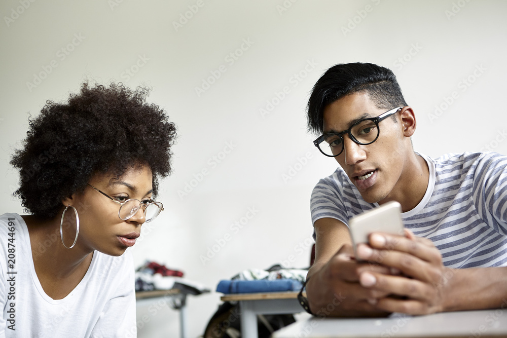 Student showing classmate smart phone Stock Photo | Adobe Stock