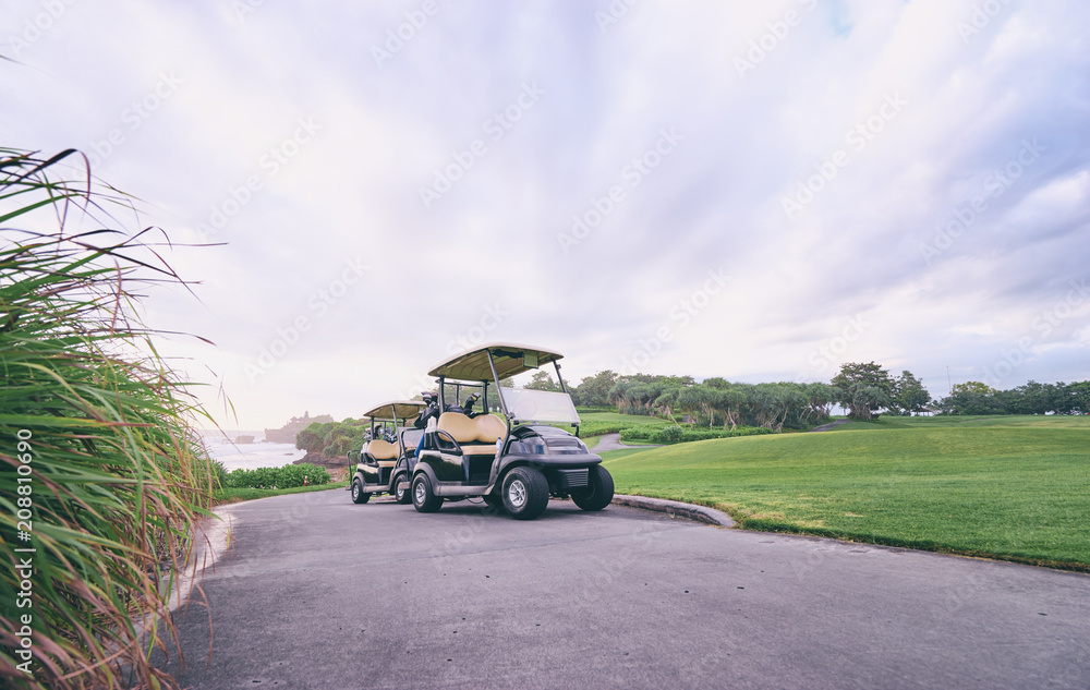 The golf course landscape with beautiful sky. Golf carts at the green ...