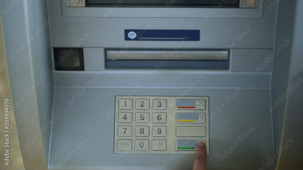 Man entering PIN number on ATM keyboard, banking transaction top view ...