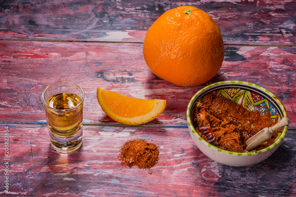 Mezcal shot mexican drink with orange slices, chili pepper and worm ...