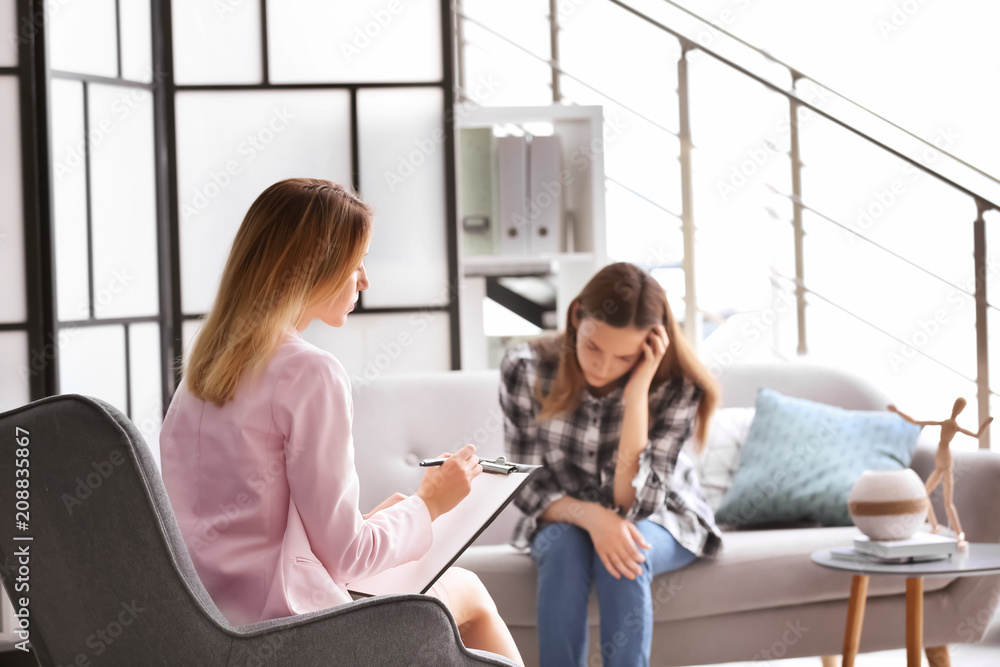 Child psychologist working with teenage girl in office Stock Photo ...