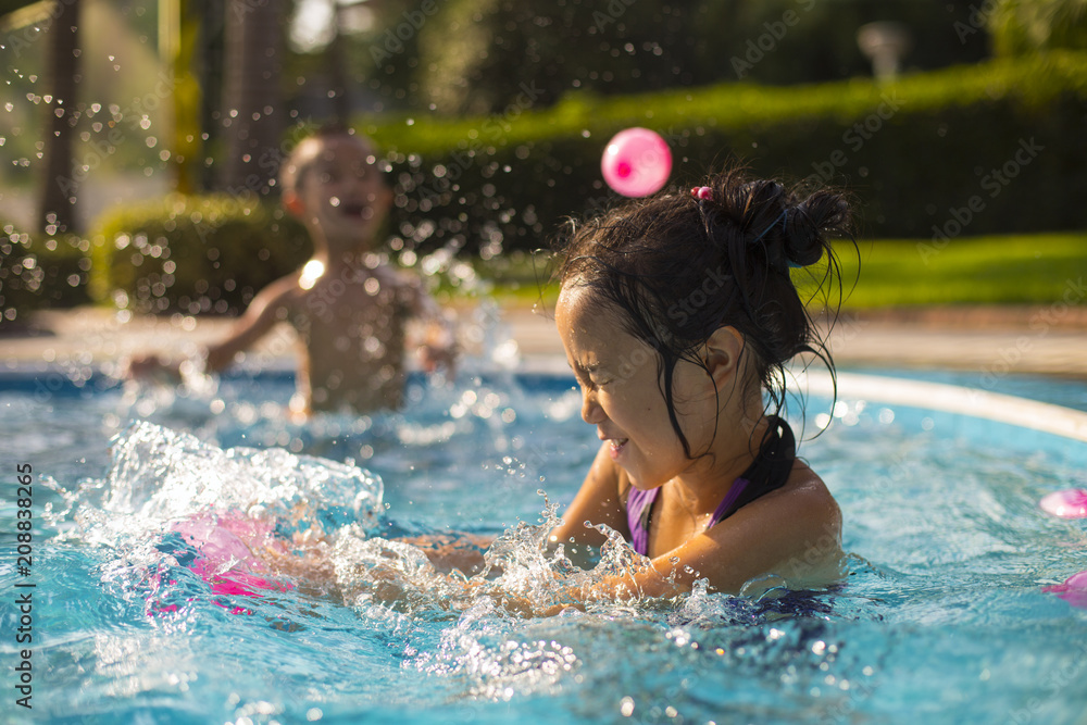 Two happy asian kids playing in the swimming pool Stock Photo | Adobe Stock