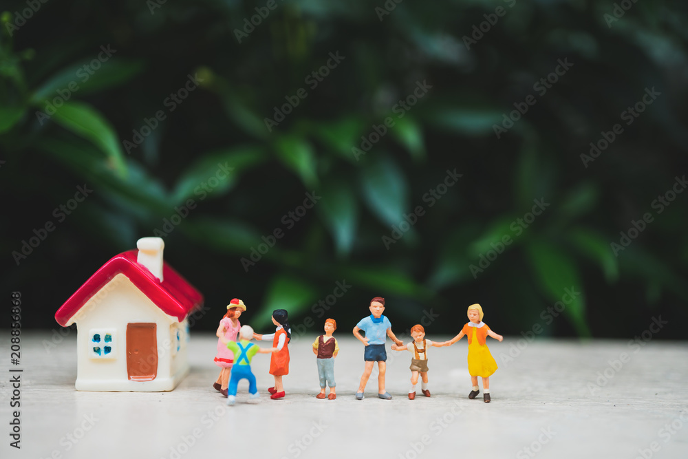 Miniature people, group of children playing on green nature background ...