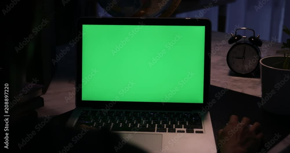 Over the shoulder view of typing and watching on computer . Green ...