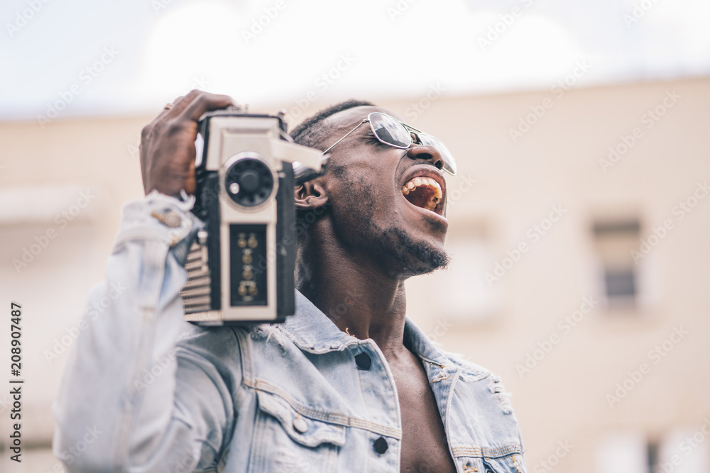 African man with vintage radio device. Stock Photo | Adobe Stock
