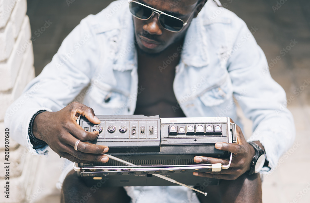 African man with vintage radio device. Stock Photo | Adobe Stock