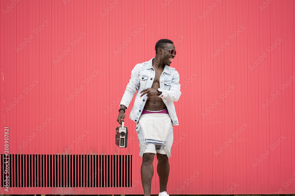 African man red background with vintage radio device. Stock Photo ...