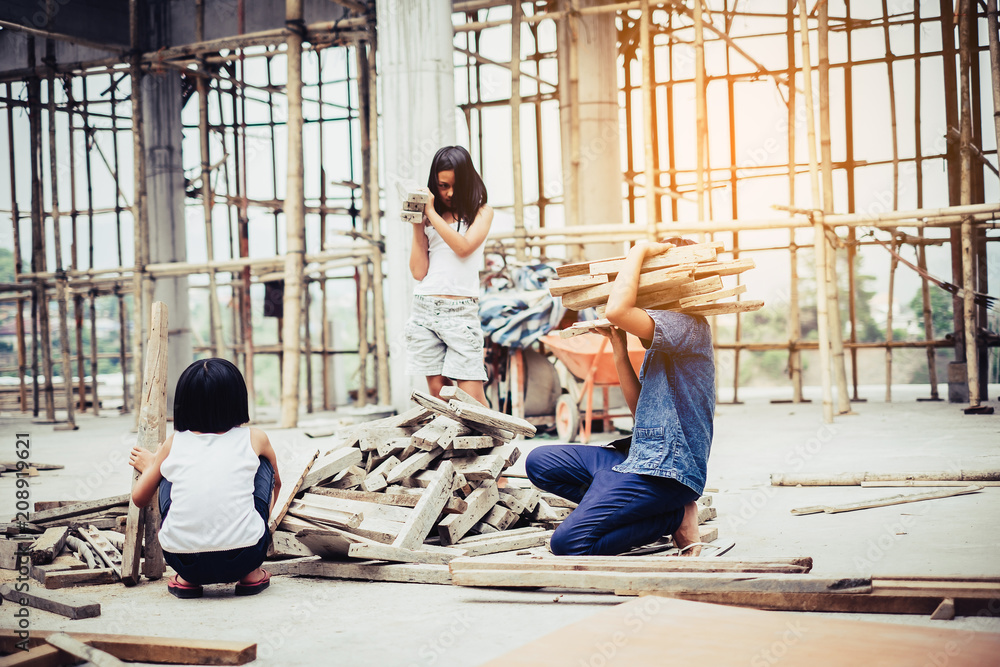 Group of little girl labor working in commercial building structure ...