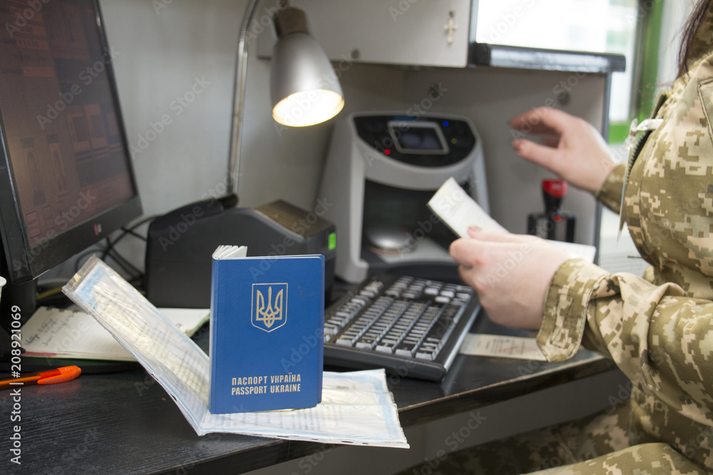 Fotka „Ukrainian passport. Border Control check in. The process of ...