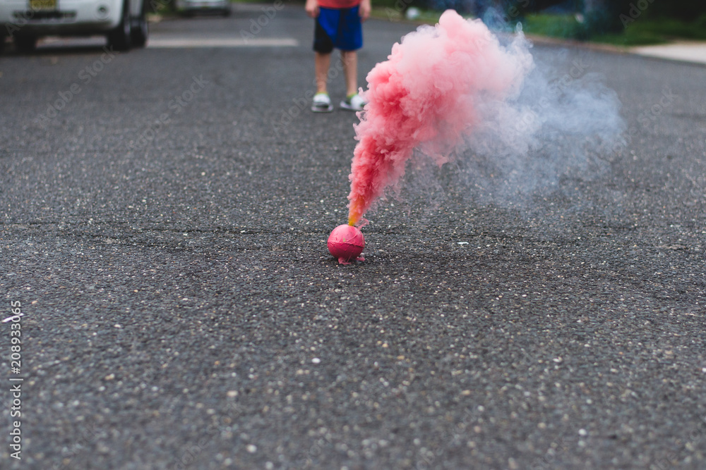 Red Smoke Bomb in Street with Child Watching Stock Photo | Adobe Stock