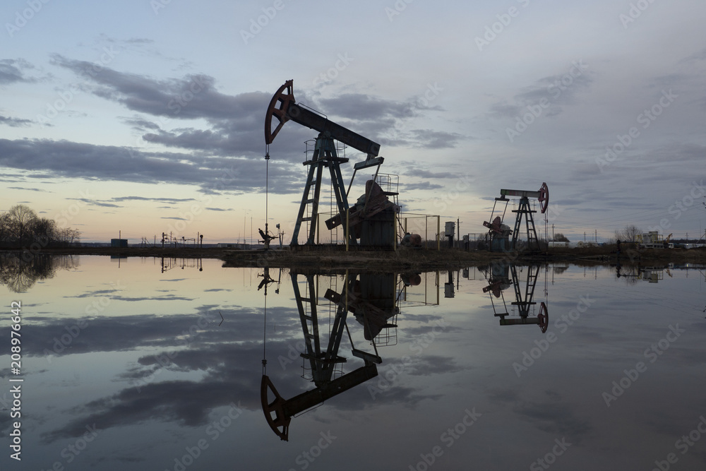 The beam pumping unit is homework, sunset in oil field. Oil pump oil ...