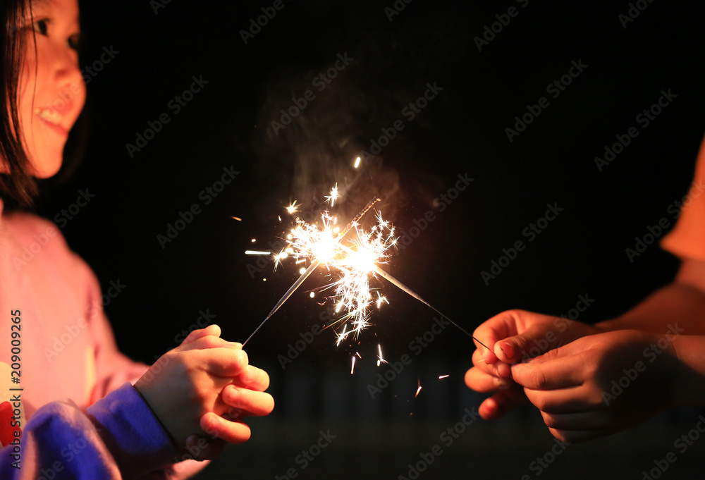 Happy little Asian child girl enjoy playing firecrackers. Stock-Foto ...