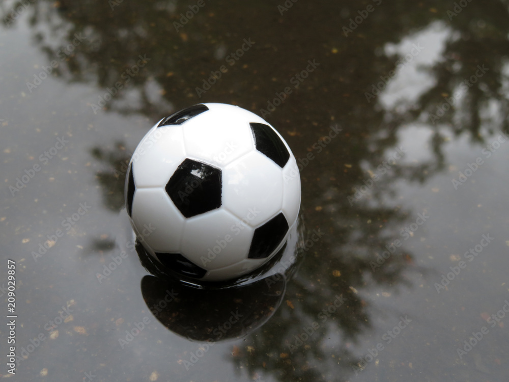 Soccer ball in the puddle. Football match in rainy weather Stock Photo ...