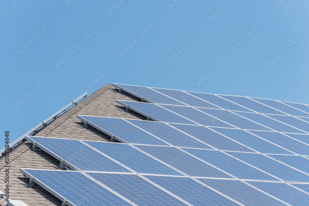 Renewable clean vs. traditional energy. Close-up solar panel system on ...