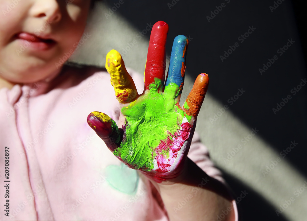 Cute little child with painted hands Stock Photo | Adobe Stock