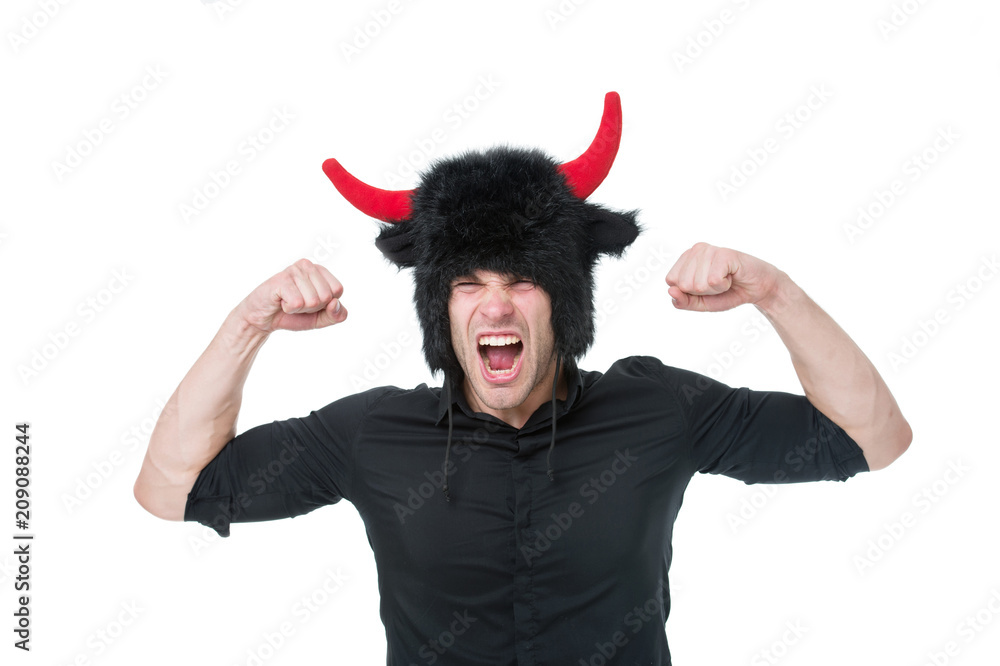 Feeling so angry. Man shouting face wears hat of devil with horns. Guy ...