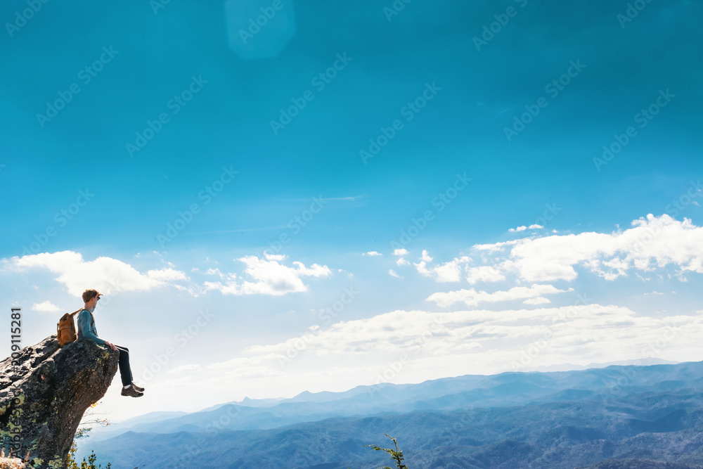 Man Sitting On Cliff Edge