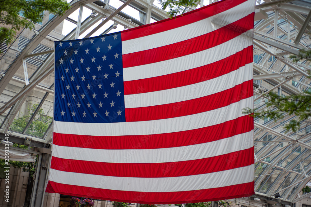 Big American (USA) flag hanging from rafters construction. Side View ...