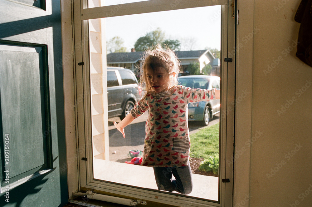 little girl presses face against screen door Stock Photo | Adobe Stock