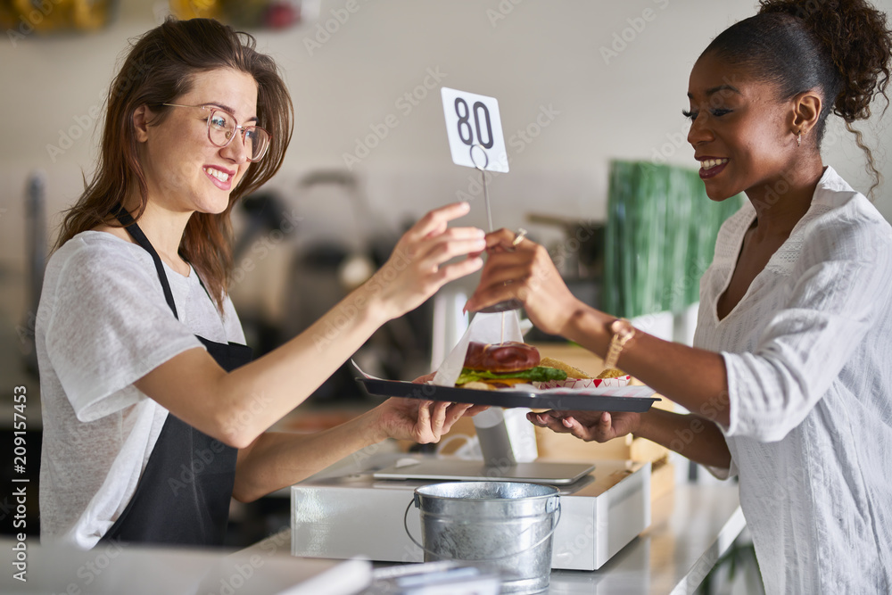 waitress handing order of food on tray to customer Stock Photo | Adobe ...