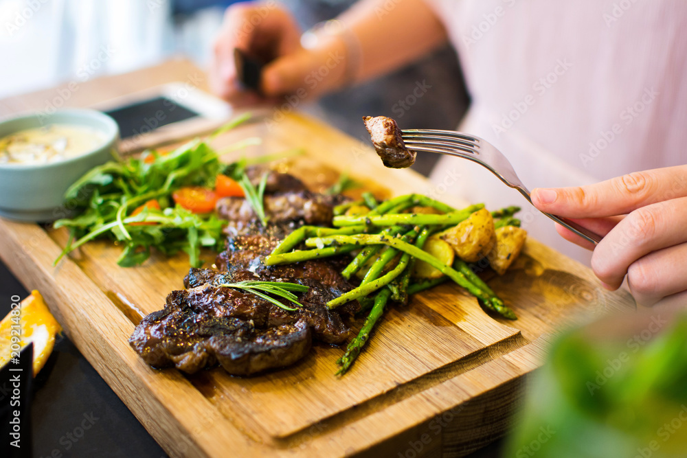 Female having a steak in the restaurant Stock Photo | Adobe Stock