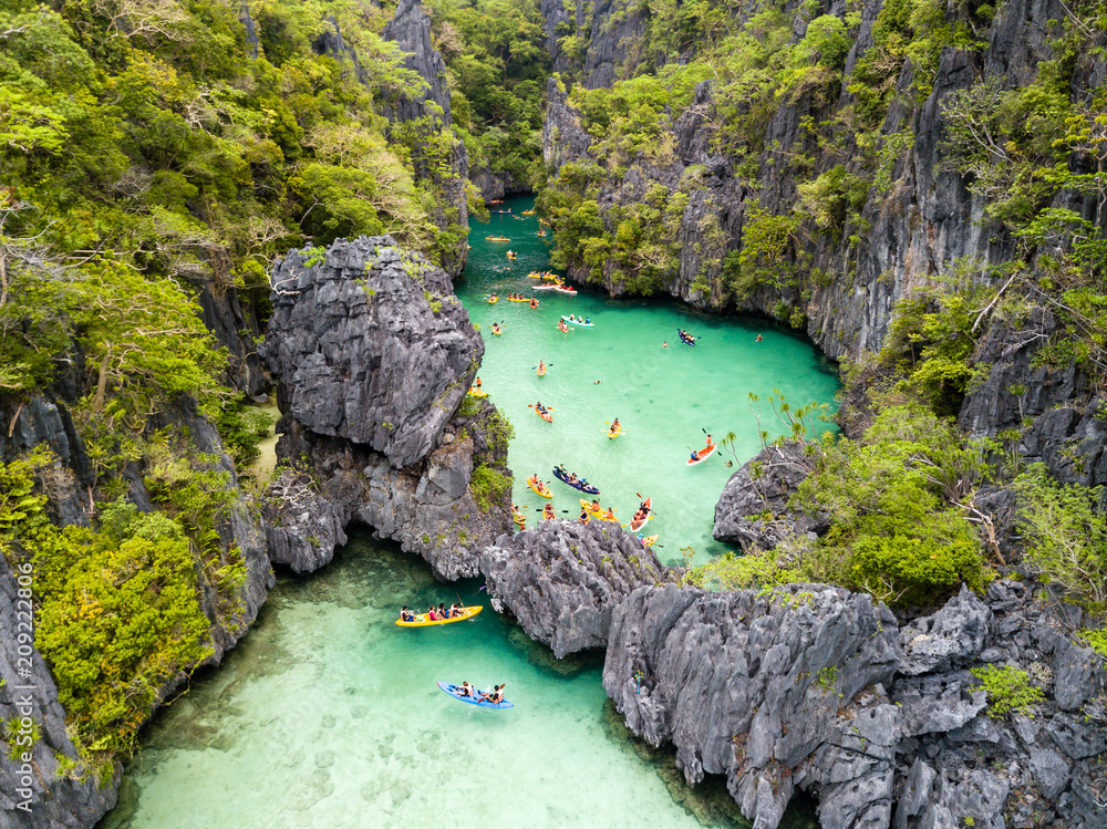 Aerial drone view of kayaks inside a beautiful shallow tropical lagoon ...