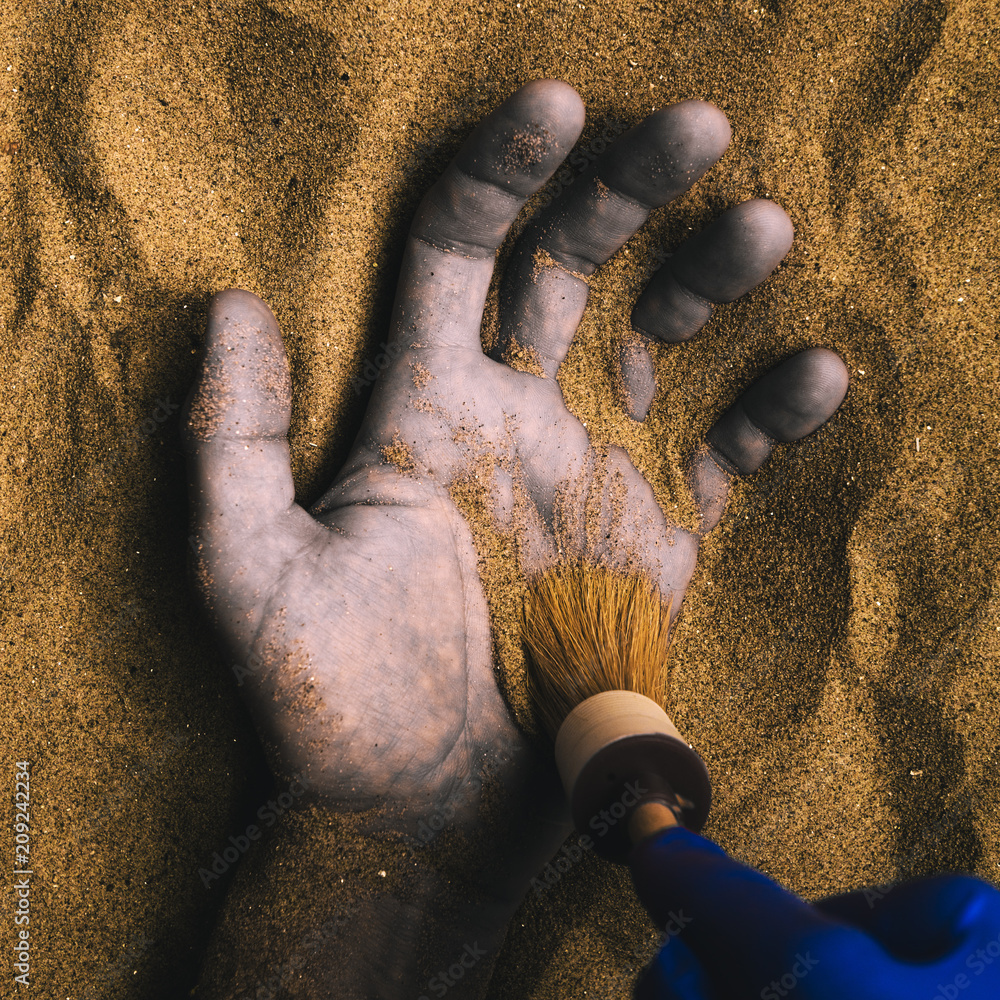Forensic expert discovering dead body buried in desert sand Stock Photo ...