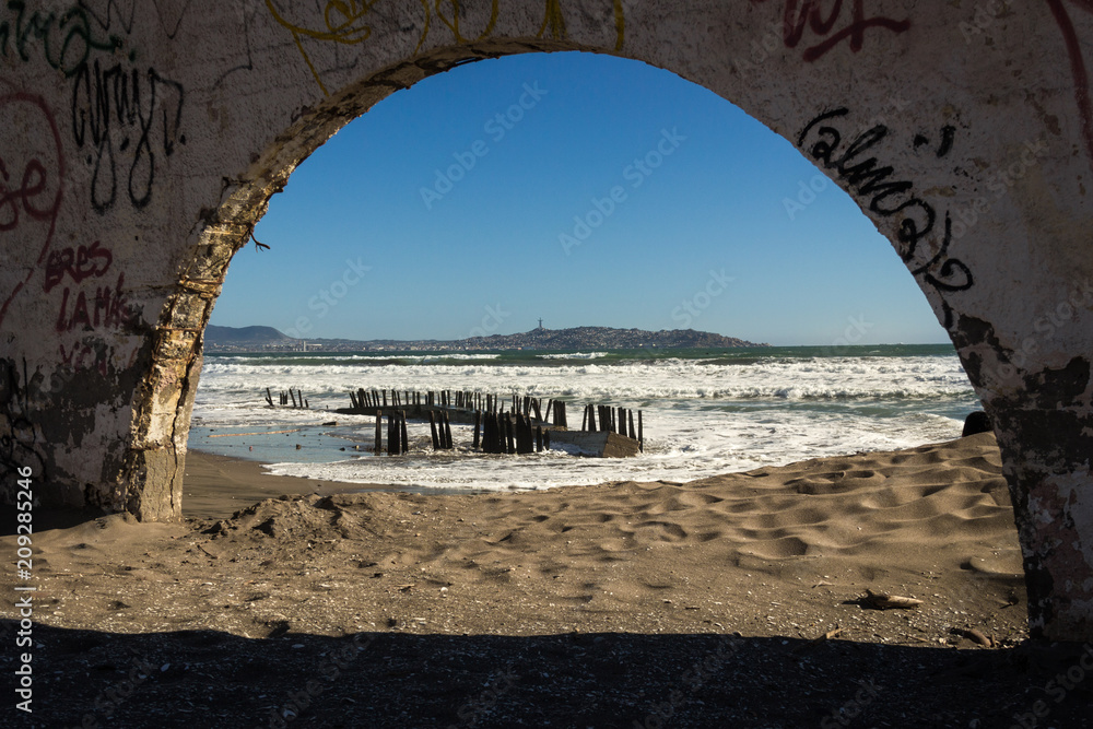 Arc of ruined fortress in La Serena with views of Coquimbo city on the ...