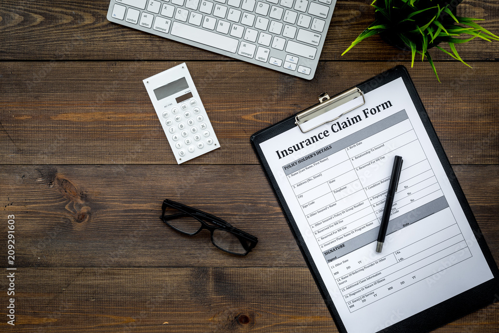 Insurance event concept. Insurance claim form on dark wooden office ...