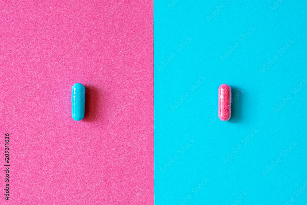 Pink and blue capsules, pills isolated on bicolor pink and blue colored ...