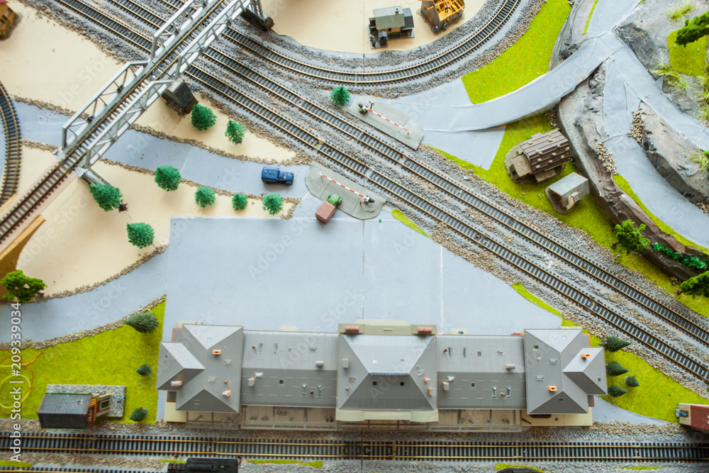 A breadboard model of a railway with a locomotive, wagons, trees ...